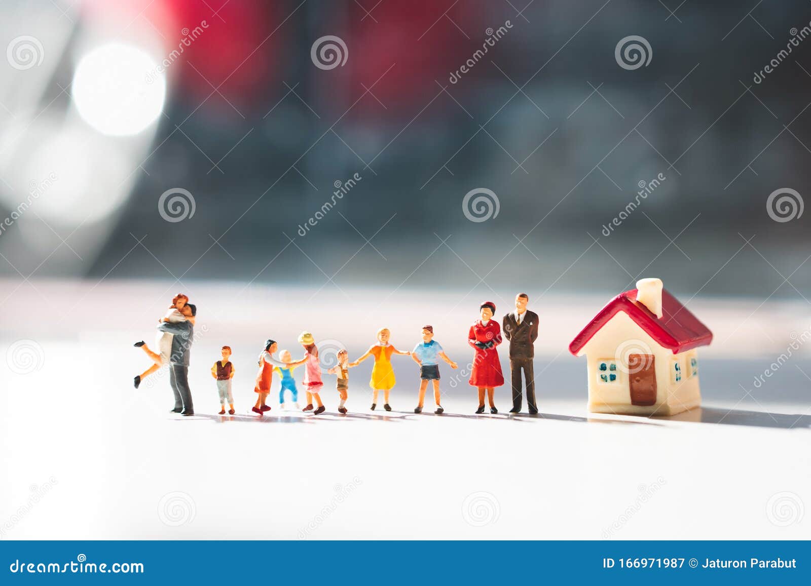 Miniature People, Big Family Standing with Mini House Stock Image ...