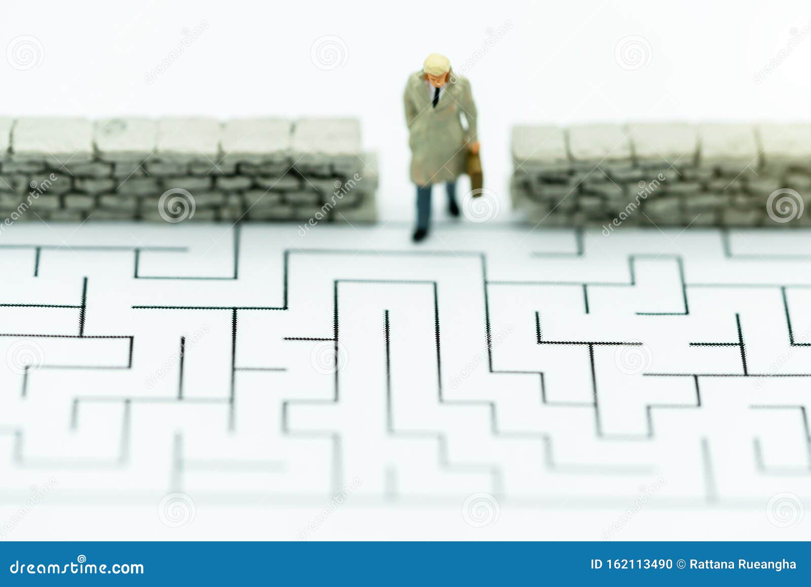 Miniature People: Businessman Walking To Wall in Maze. Concepts of ...