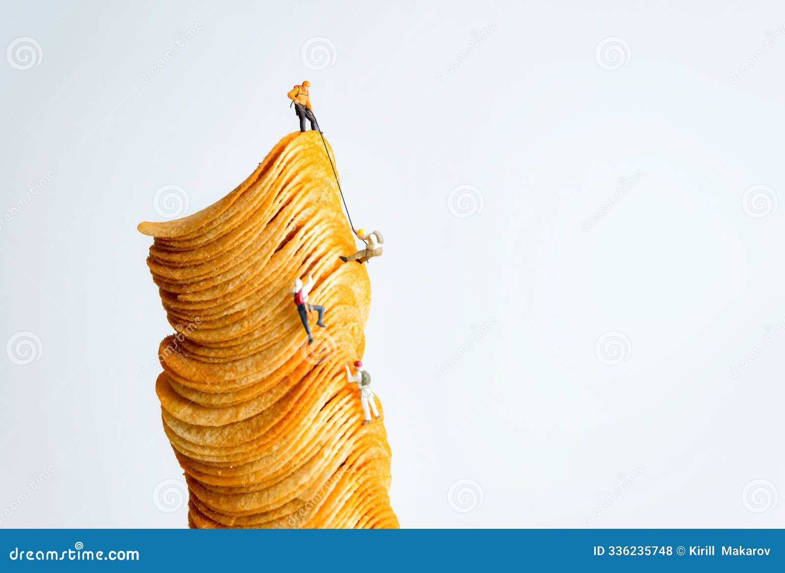 Miniature People Climbing a Huge Stack of Potato Chips Representing ...