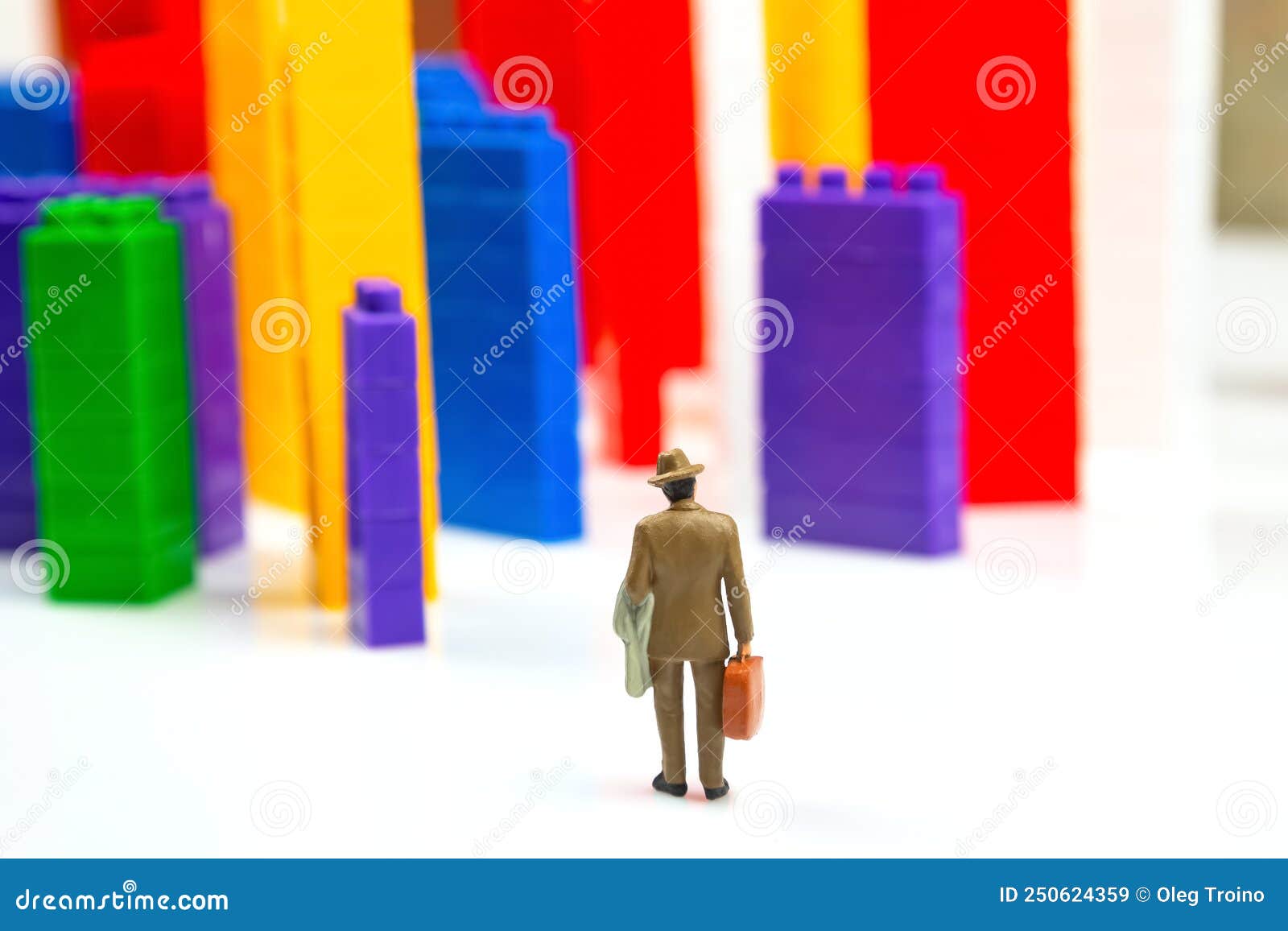 Miniature People. Figures of People Stand Near the Colored Blocks of a ...