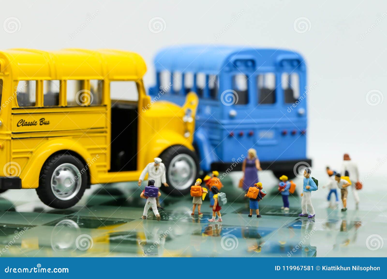 Miniature People : a Group of Young Children Getting on the Schoolbus ...
