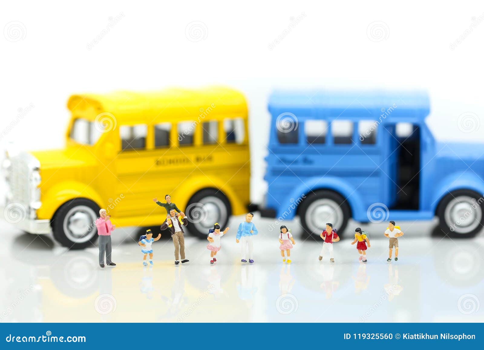 Miniature People : a Group of Young Children Getting on the Schoolbus ...