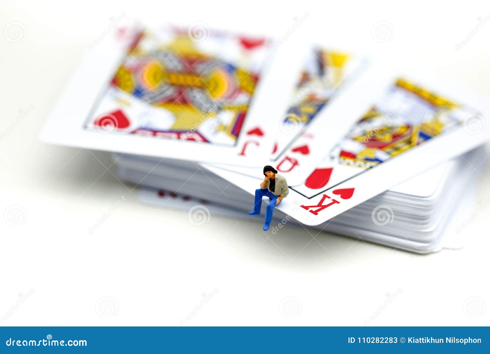 Miniature People : Man Sitting on Playing Cards. Stock Image - Image of ...