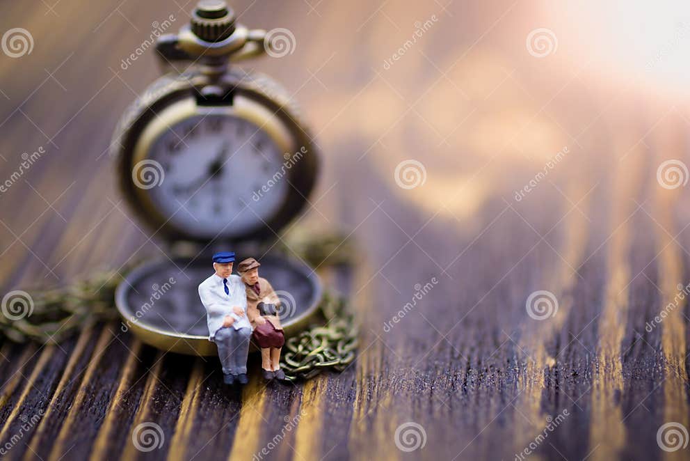 Miniature People Old Couples Are Sitting On The Clock Image Use For