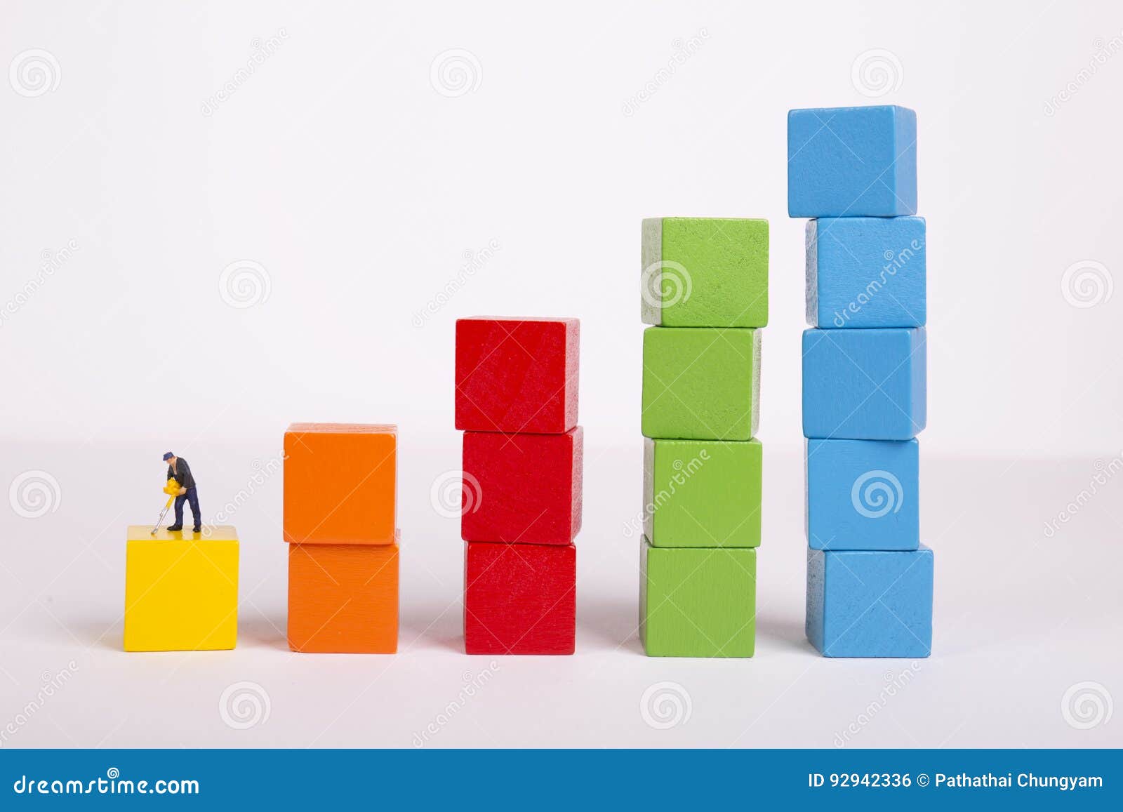 Miniature People on Stack of Colorful Wooden Cube Building Blocks ...