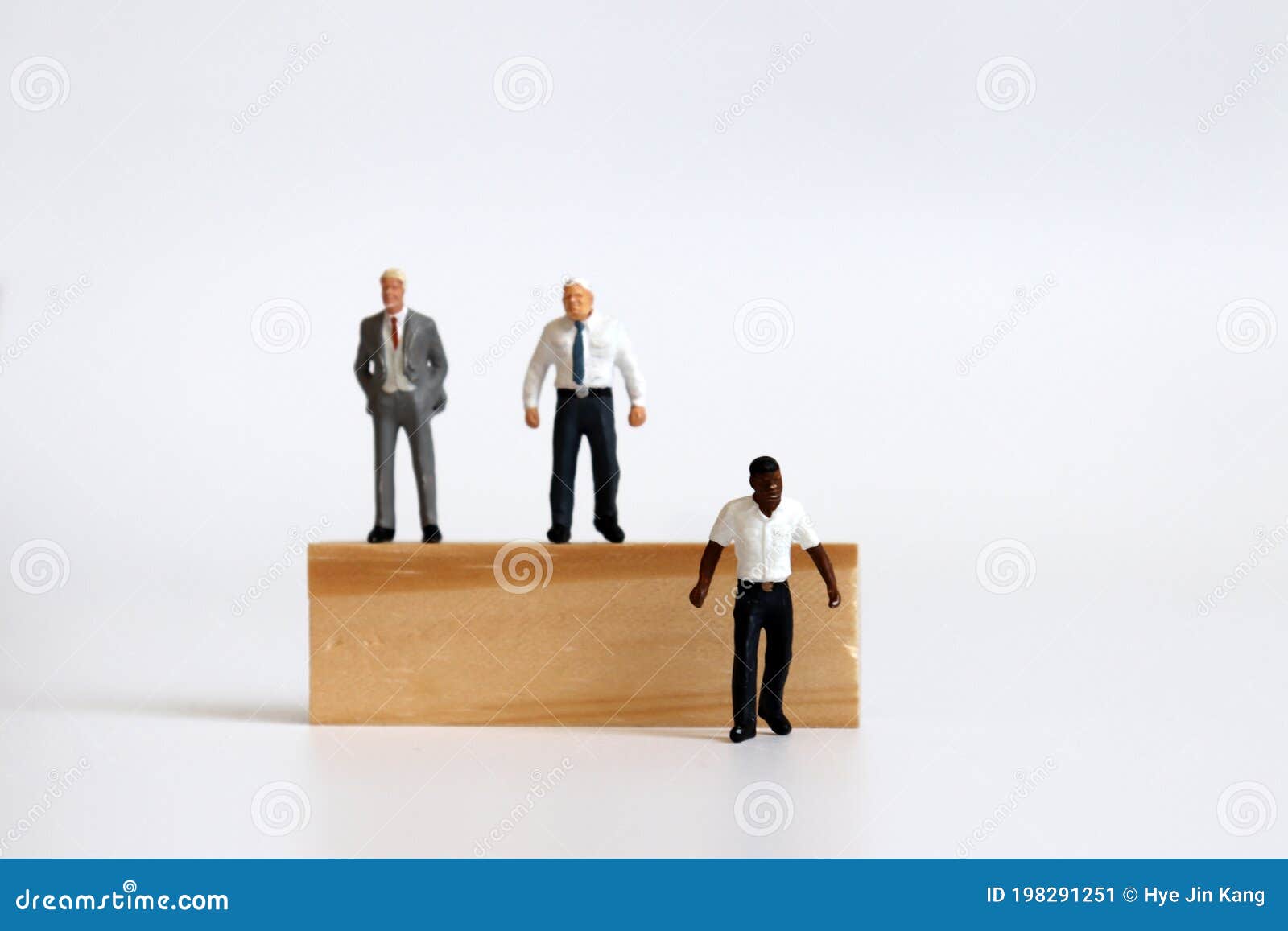 Miniature People Standing on Tree Blocks and Miniature Man Standing ...