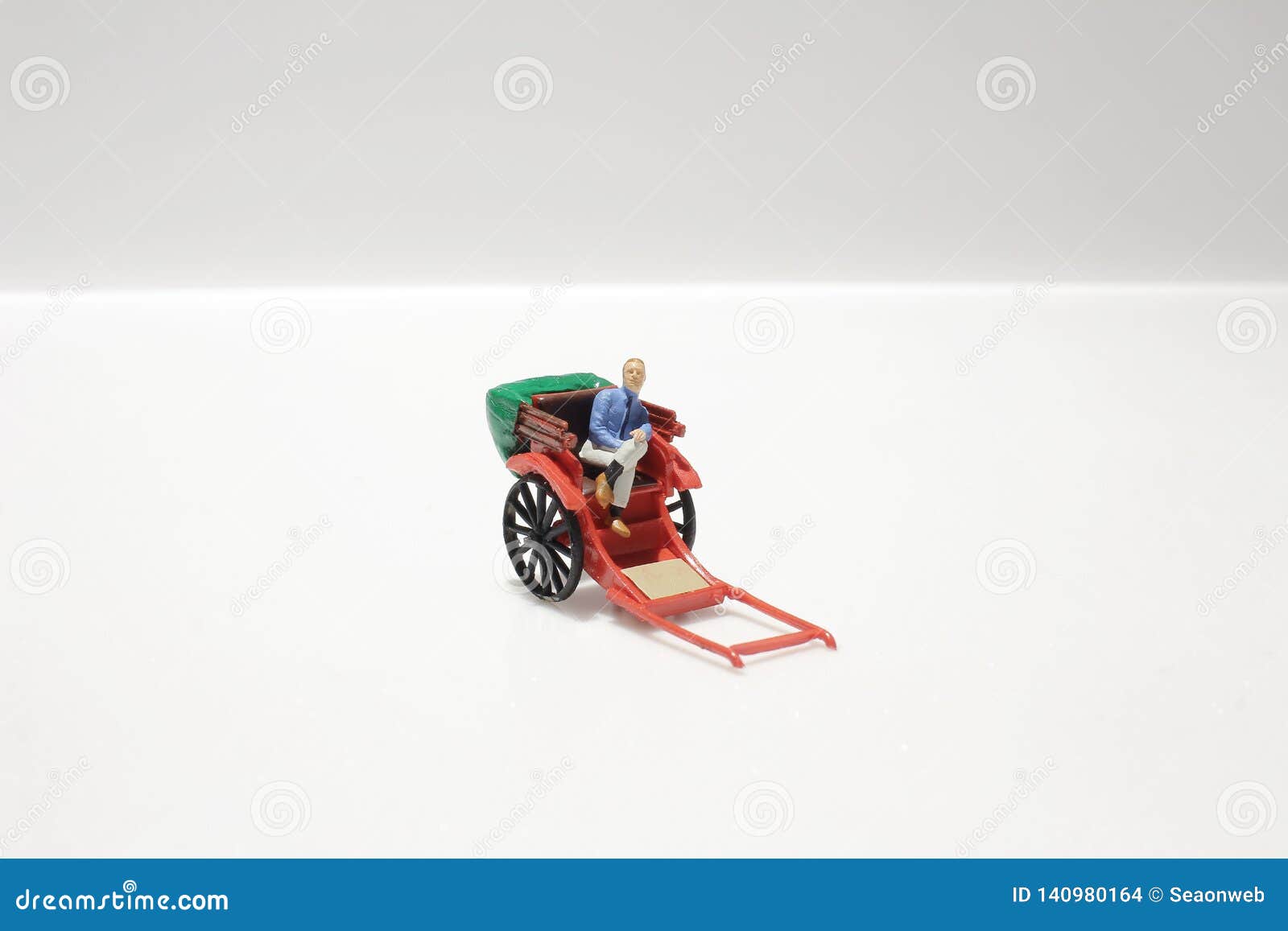 Miniature Statue and Red Vintage Oriental Rickshaw Cab Stock Photo ...