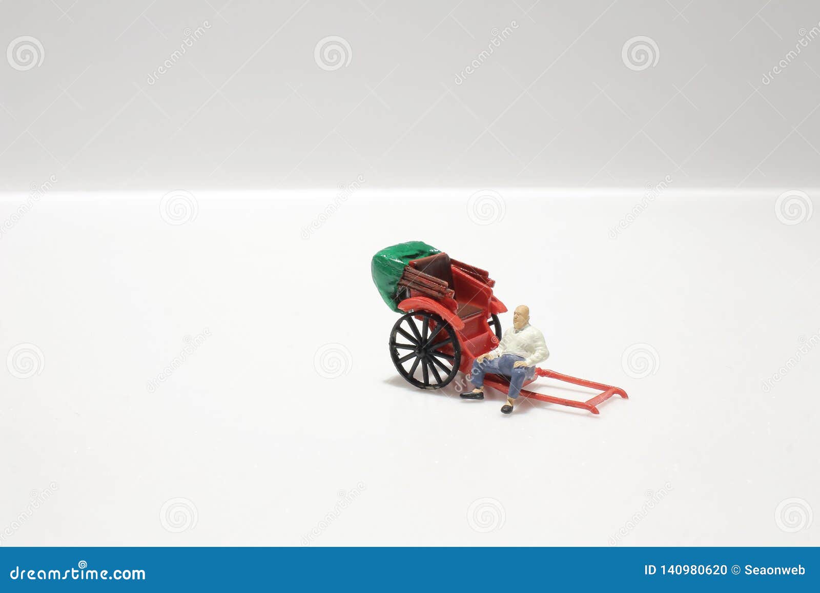 Miniature Statue and Red Vintage Oriental Rickshaw Cab Stock Photo ...