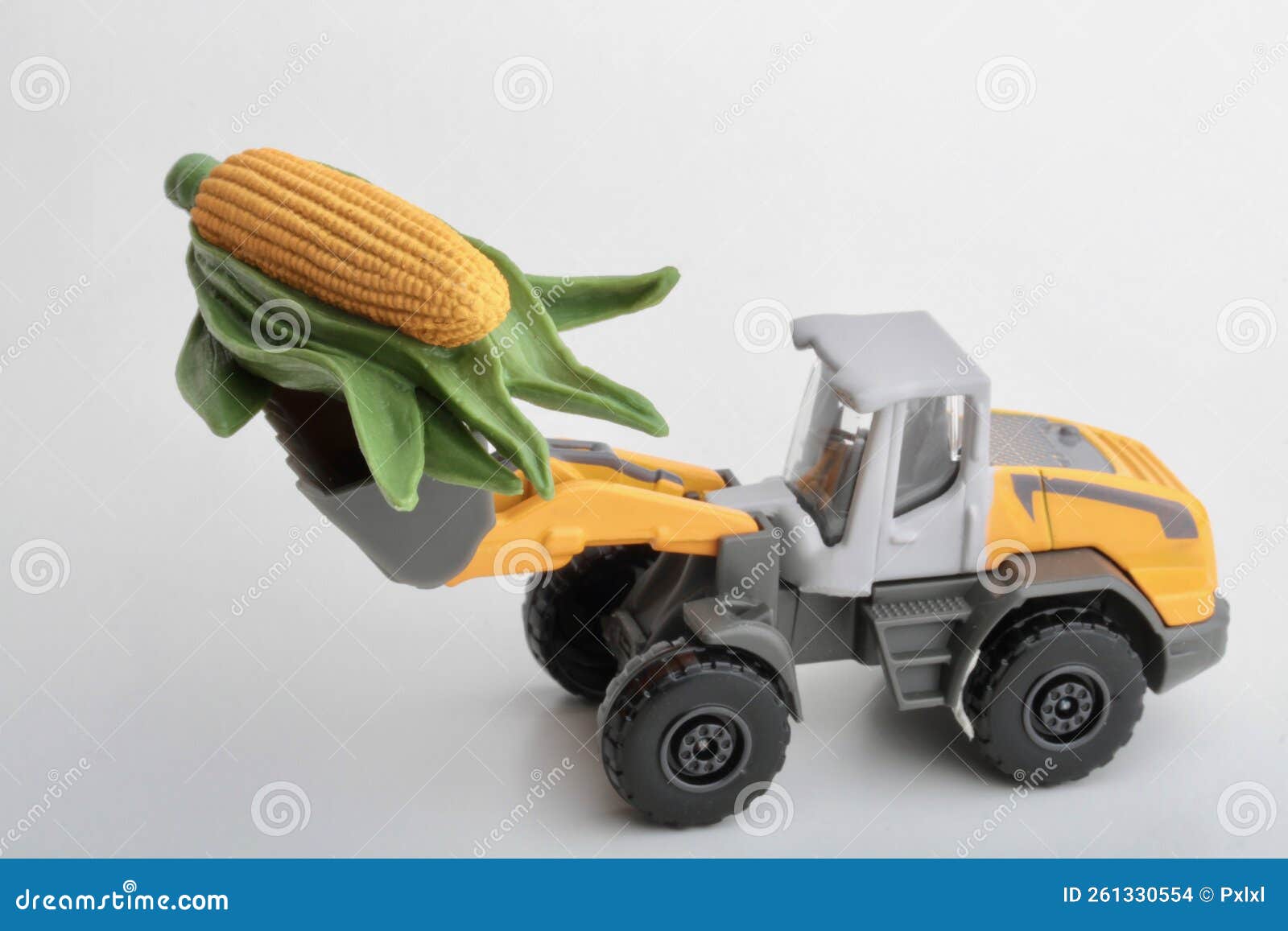Miniature Toy Excavator Lifting Up Corn Cob Stock Photo - Image of ...