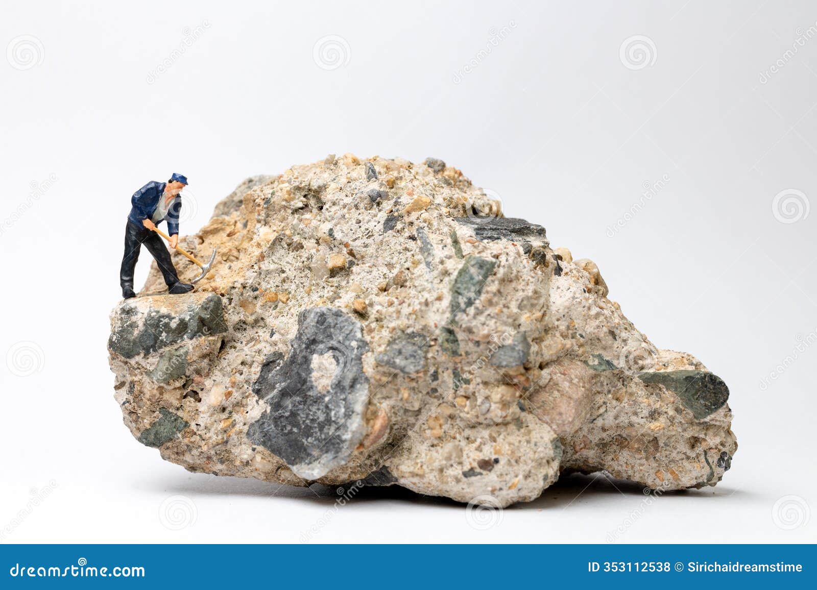 Miniature Worker Using a Pickaxe To Chip Away at a Large Rock Stock ...