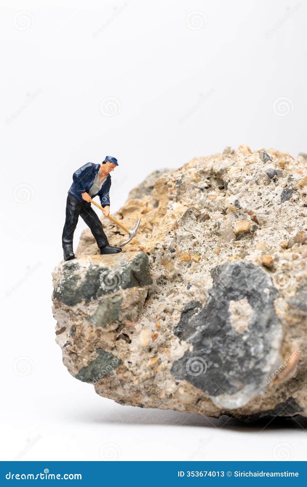 Miniature Worker Using a Pickaxe To Chip Away at a Large Rock Stock ...