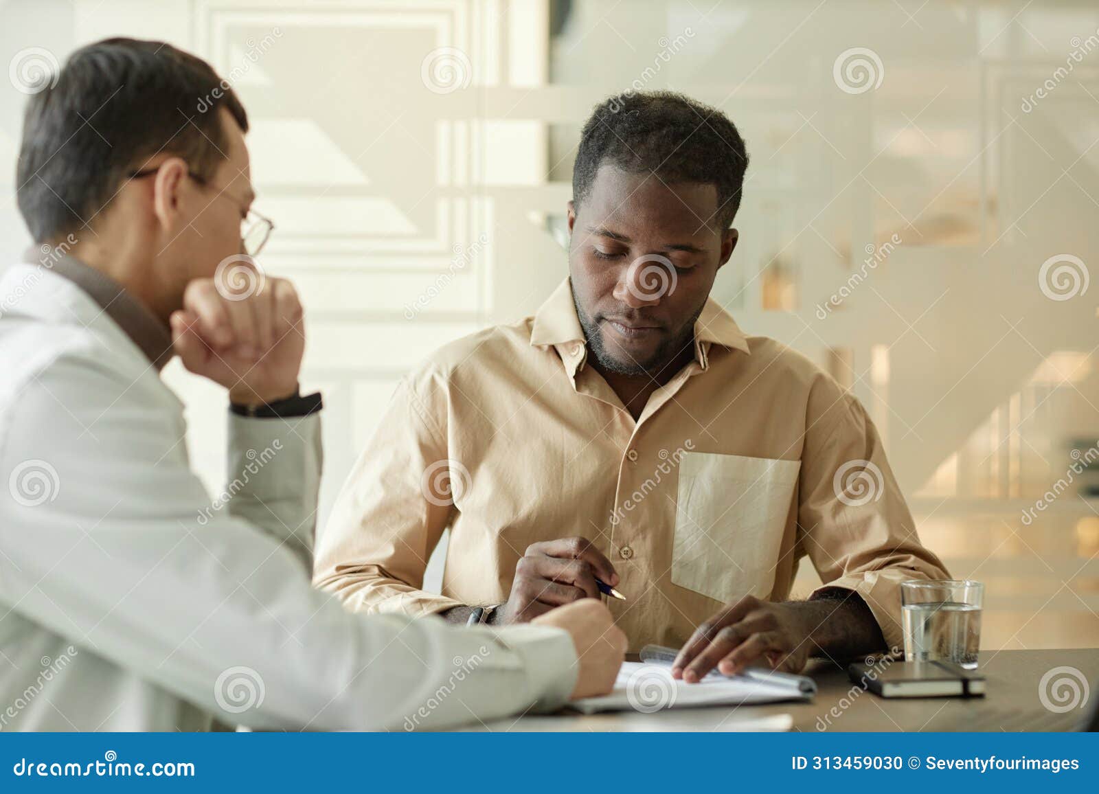 Black Man Working on Project with Colleague Stock Photo - Image of ...