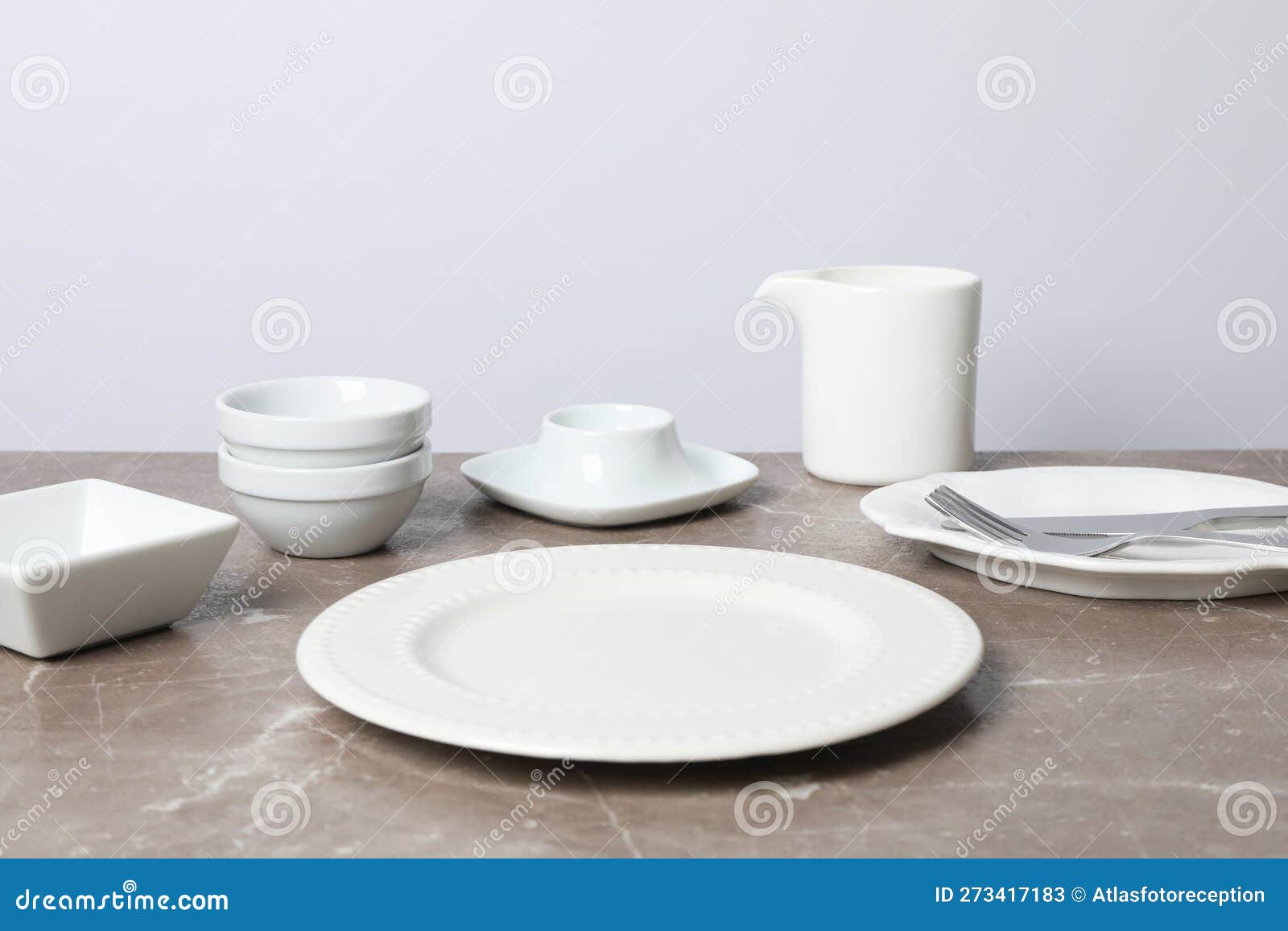 Minimal Table Setting with Blank Dish on Textured Gray Table Stock ...