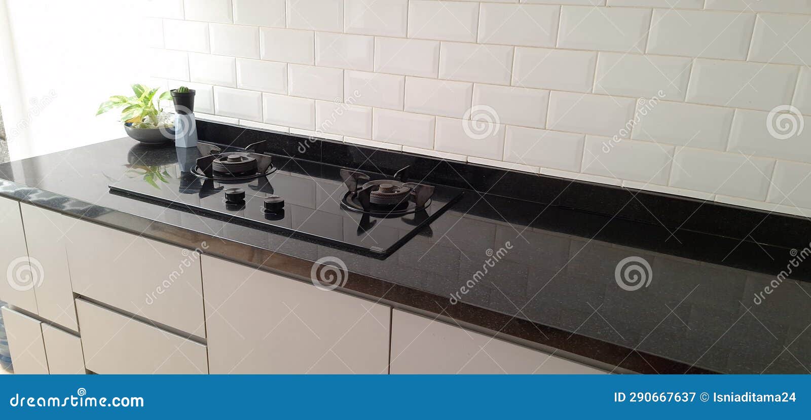 Minimalist Kitchen with Cooktop and Black Granite Table Stock Image ...