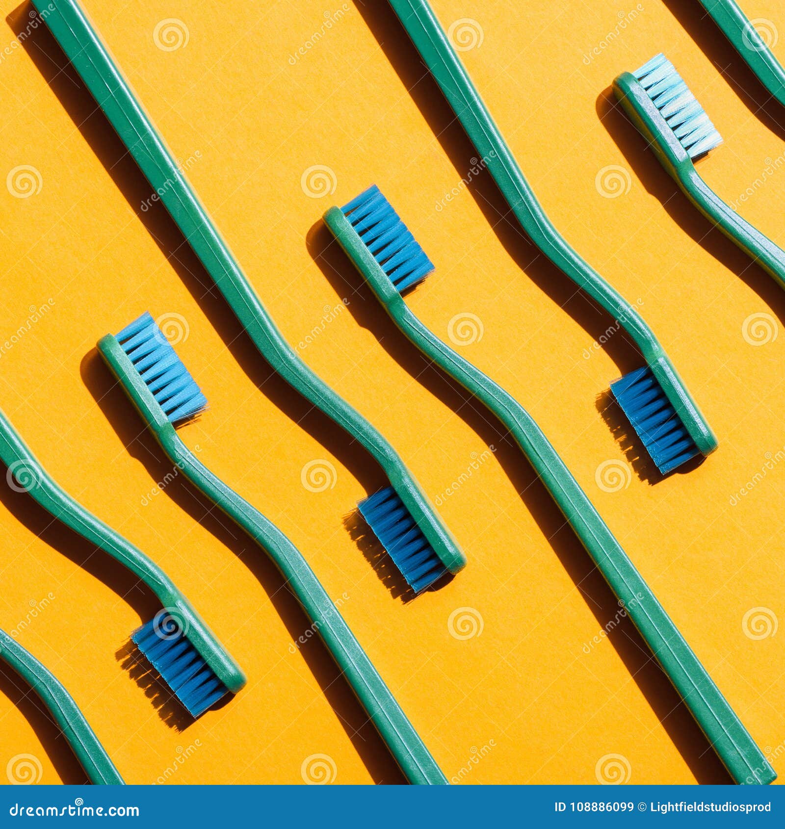 Background with Green Toothbrushes, on Yellow Stock Image - Image of ...
