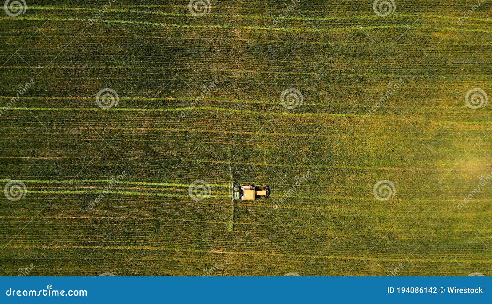 Minimalistic Overhead Shot of a Combine Mowing a Grass Field Stock ...