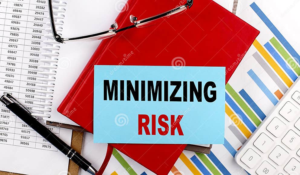 MINIMIZING RISK Text on Sticky on Red Notebook on Chart Background ...