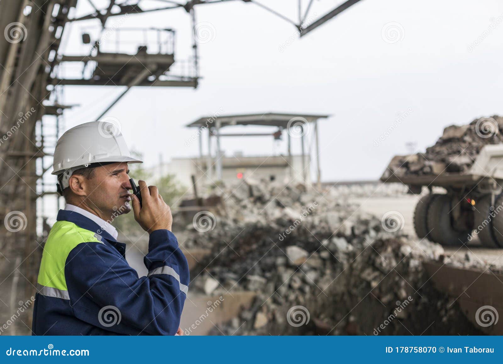 Mining Engineer in Yellow-blue Uniform White Helmet Supervises ...