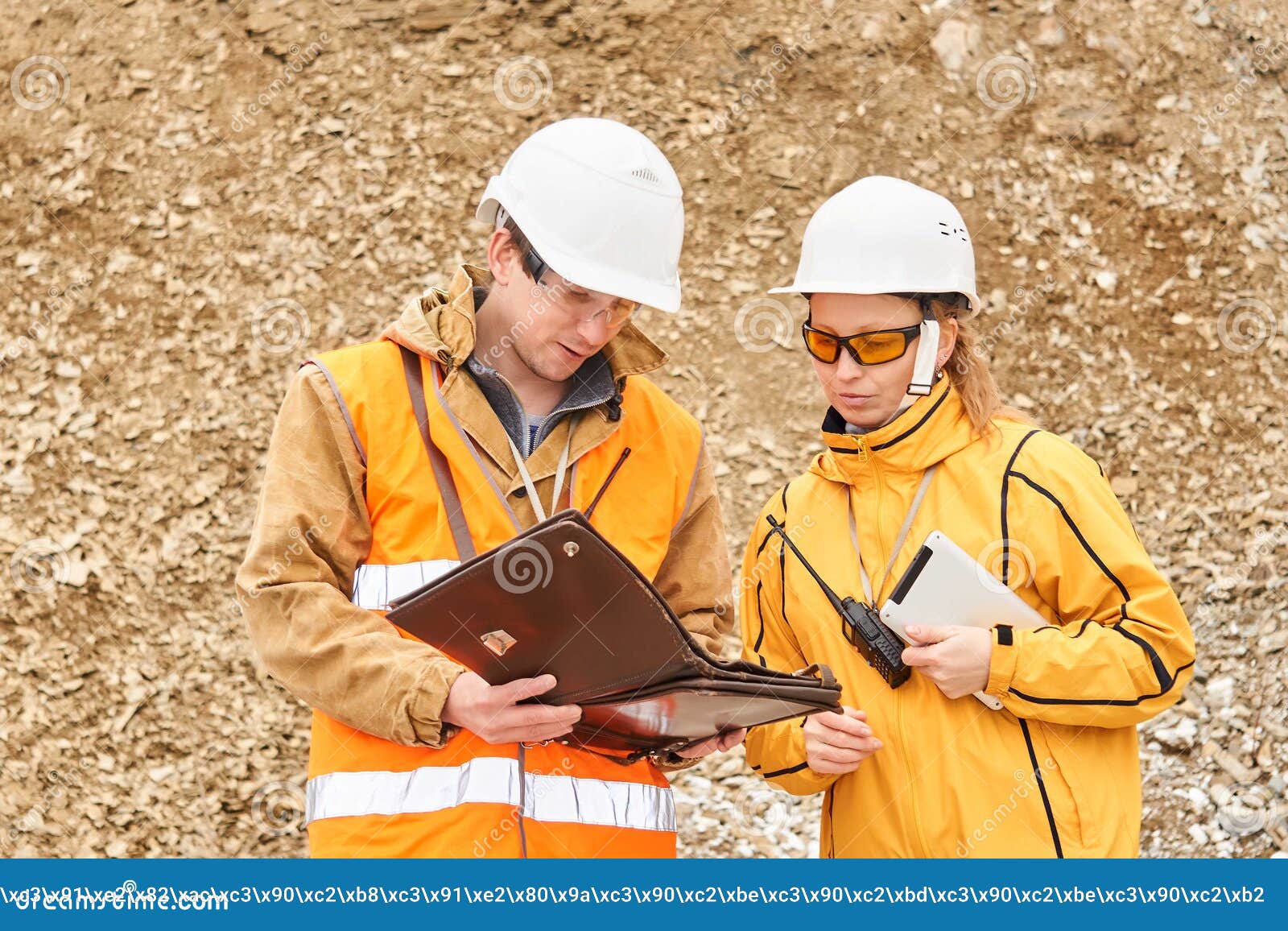 Mining Engineers Discussing Working Documentation at the Mining Site ...