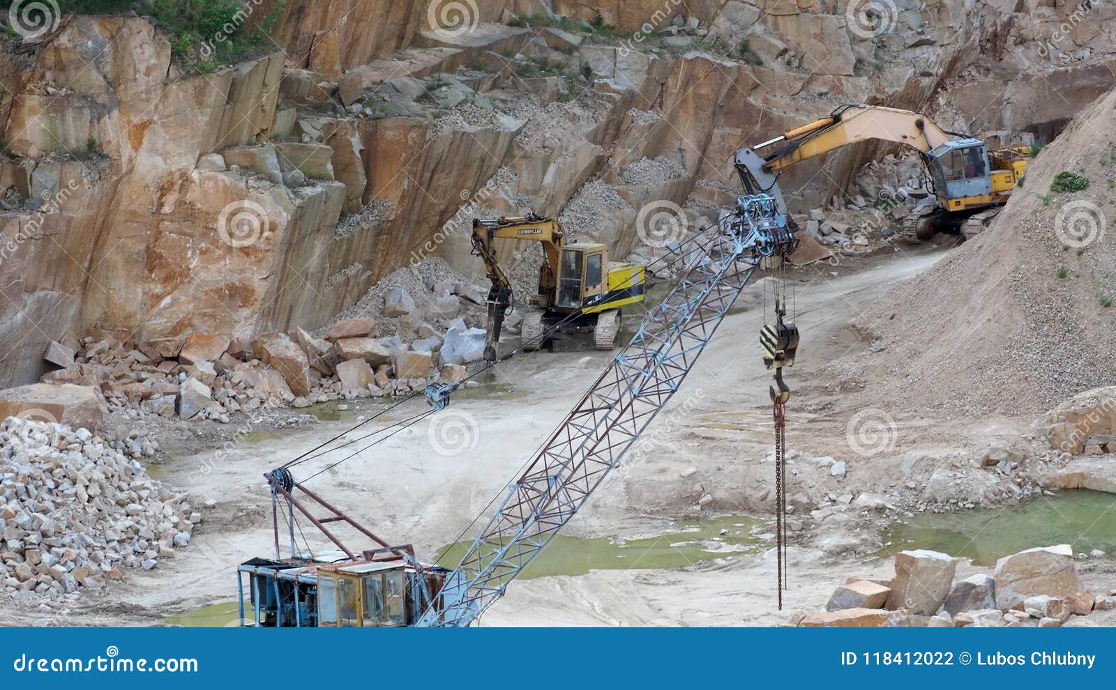 Mining in the Granite Quarry. Working Mining Machine - Old Crane and ...