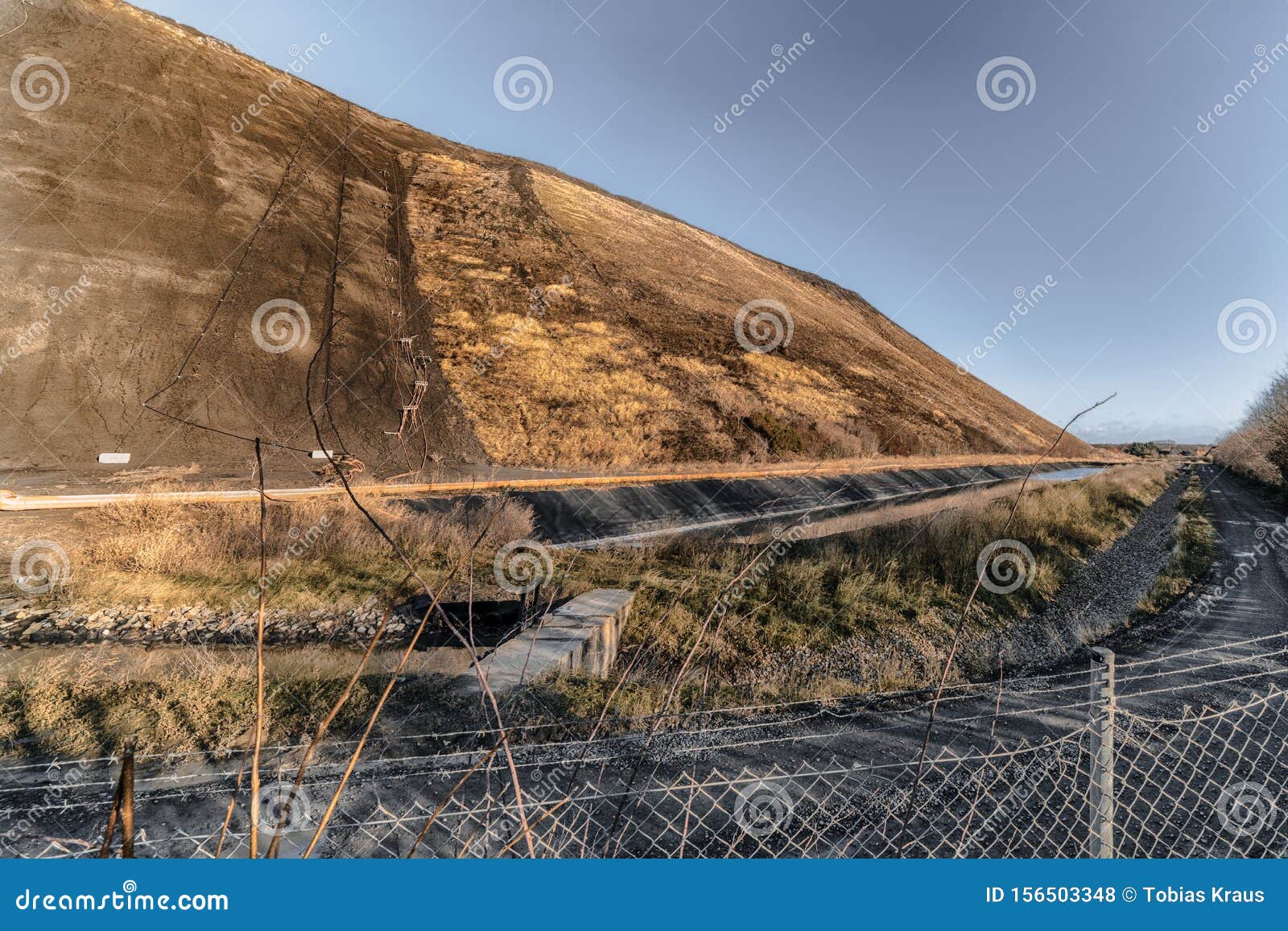 Mining Hill behind a fence stock photo. Image of brown - 156503348