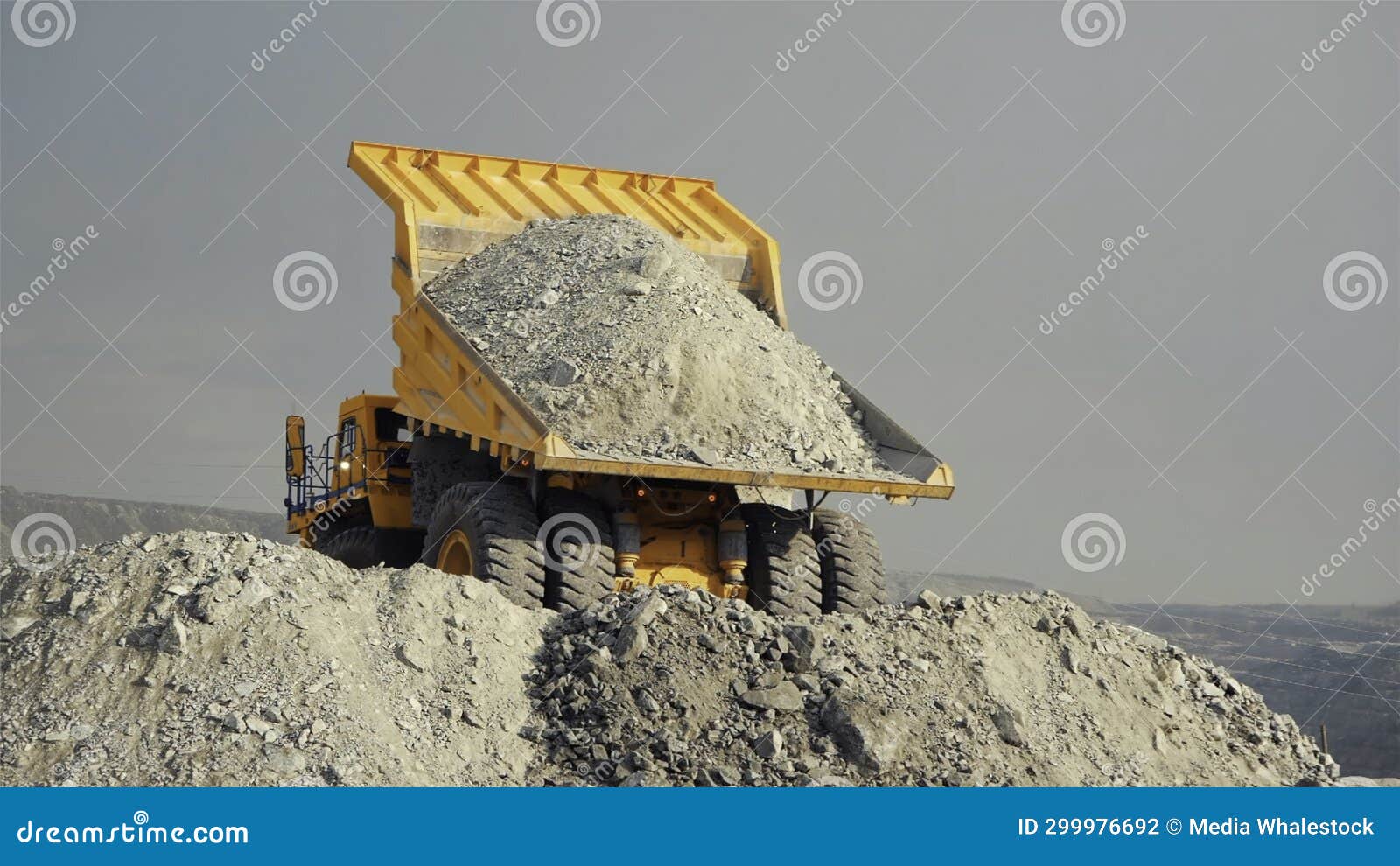 Mining Loader Unloads Limestone Ore or Rock. View from the Back. Stock ...