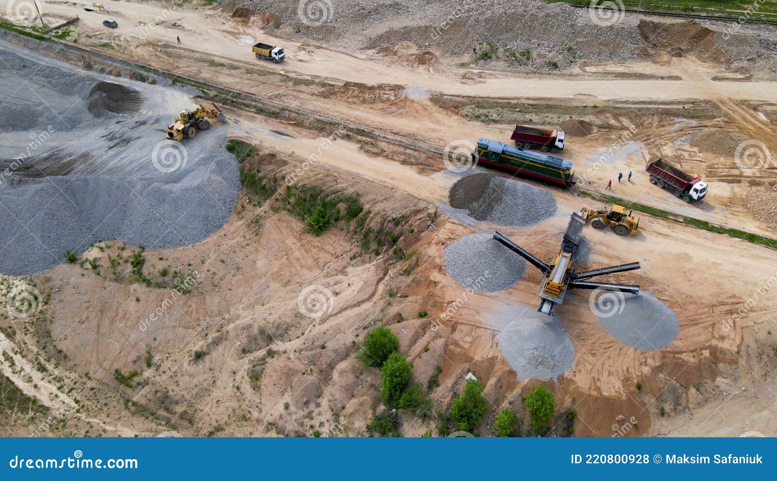 Front End Loader Loading Gravel into Jaw Crusher in Open-pit. Arial ...