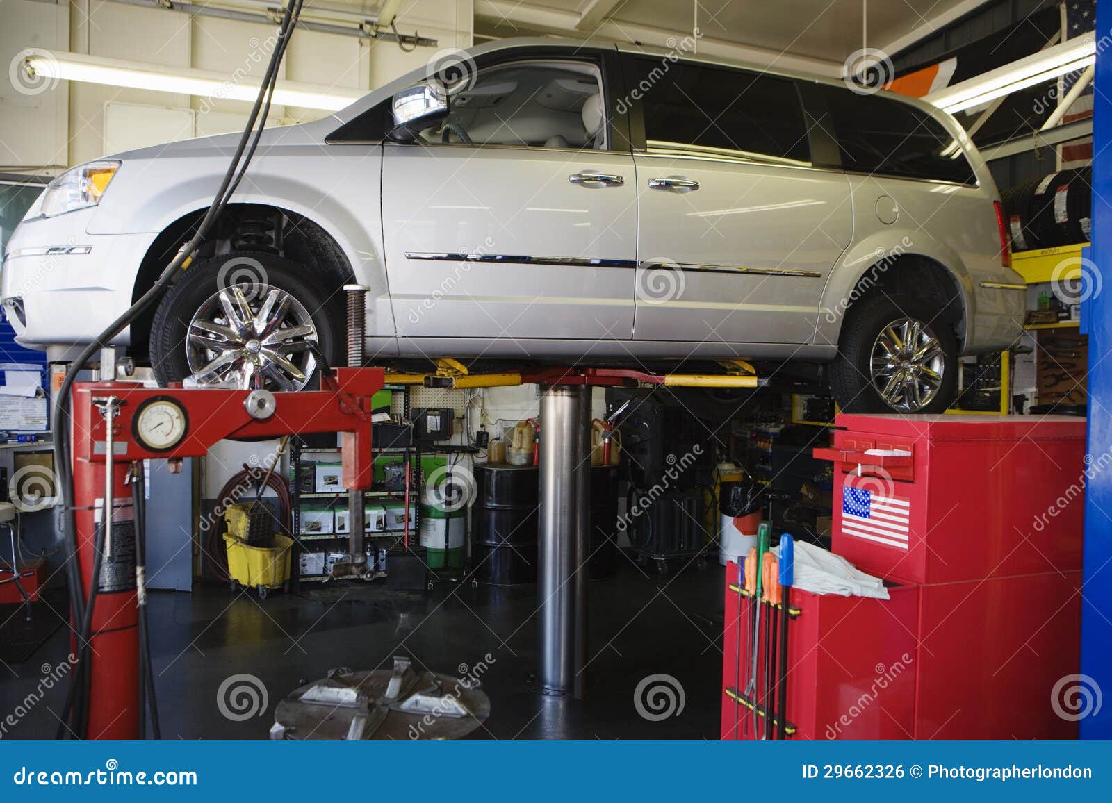 Minivan on a Lift in Garage Stock Photo - Image of lifted, hydraulic ...