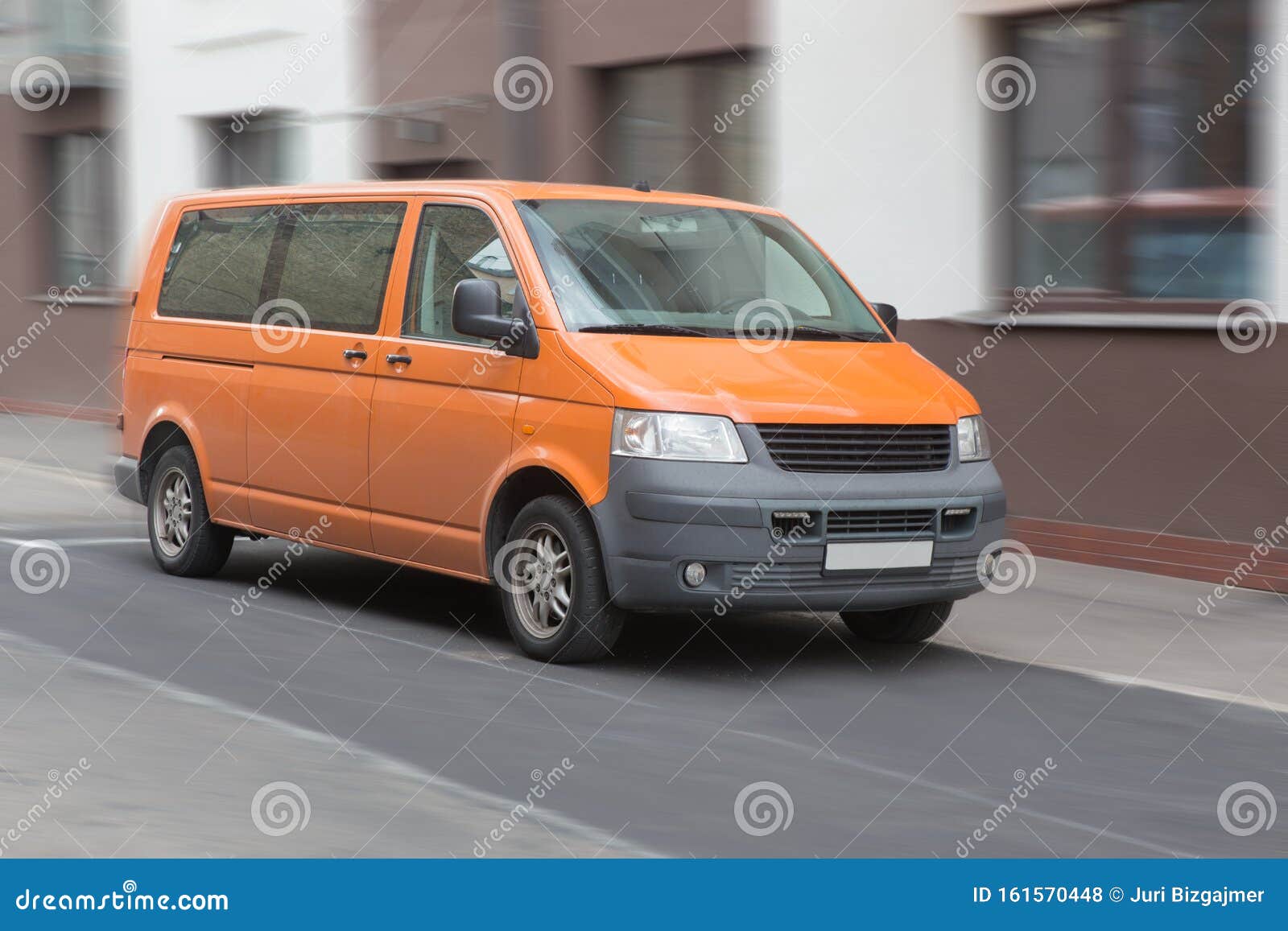 Minivan moves on street stock photo. Image of crossroad - 161570448