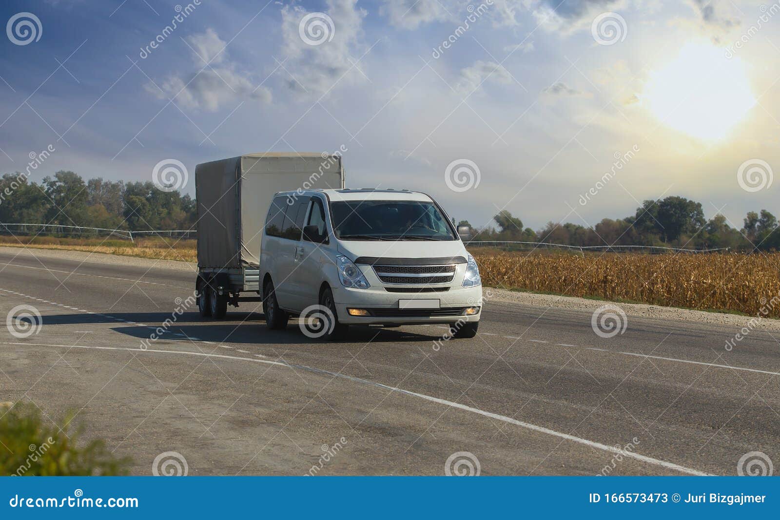 Minivan with Trailer. Moving Along a Suburban Highway Stock Image ...