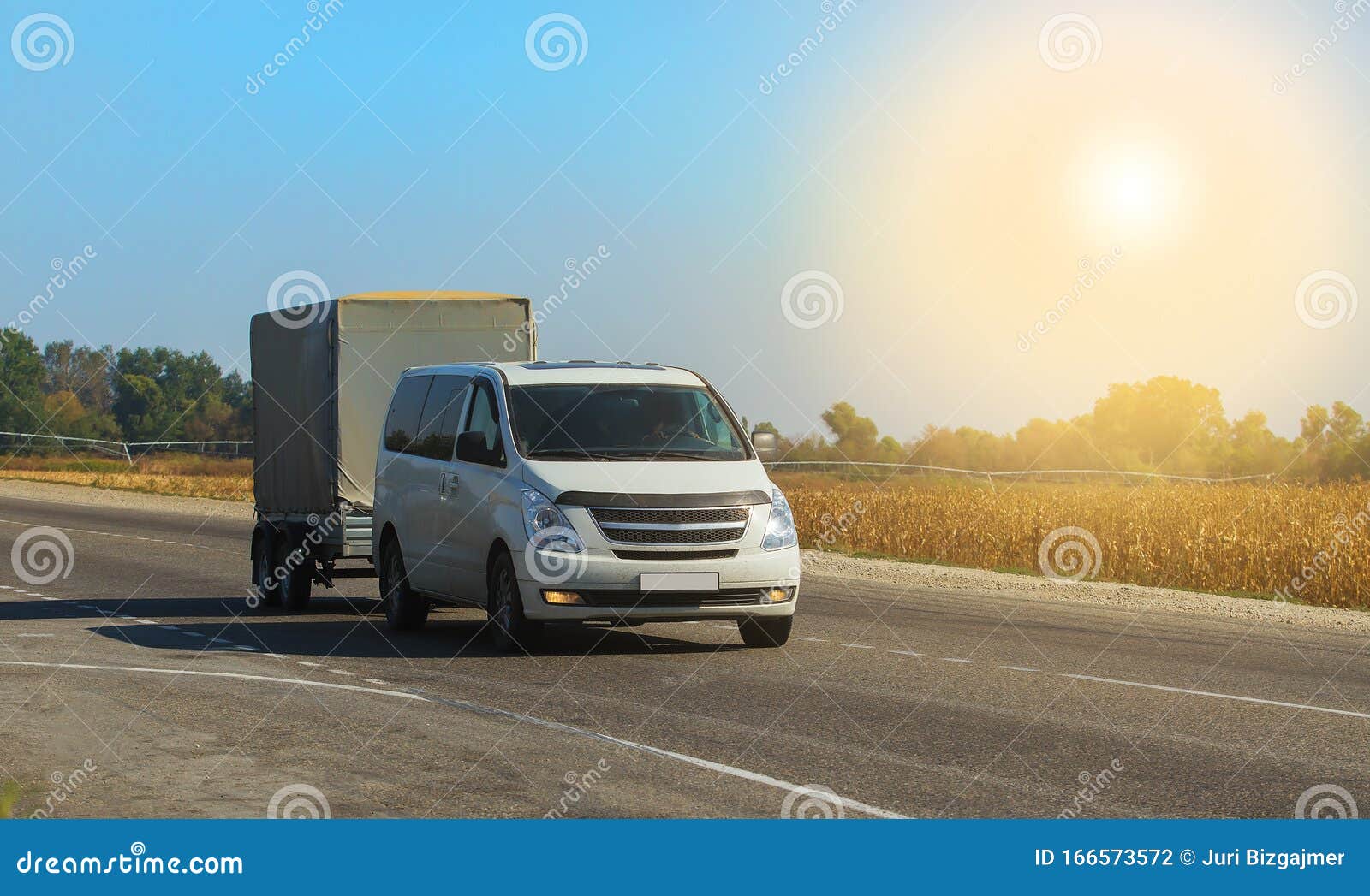 Minivan with Trailer. Moving Along a Suburban Highway Stock Photo ...