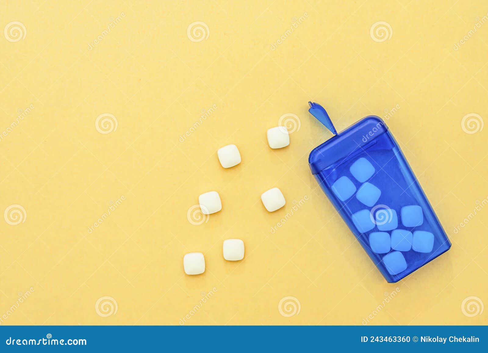 Mint Gummies Falling Out of Packaging on a Yellow Surface Stock Photo ...