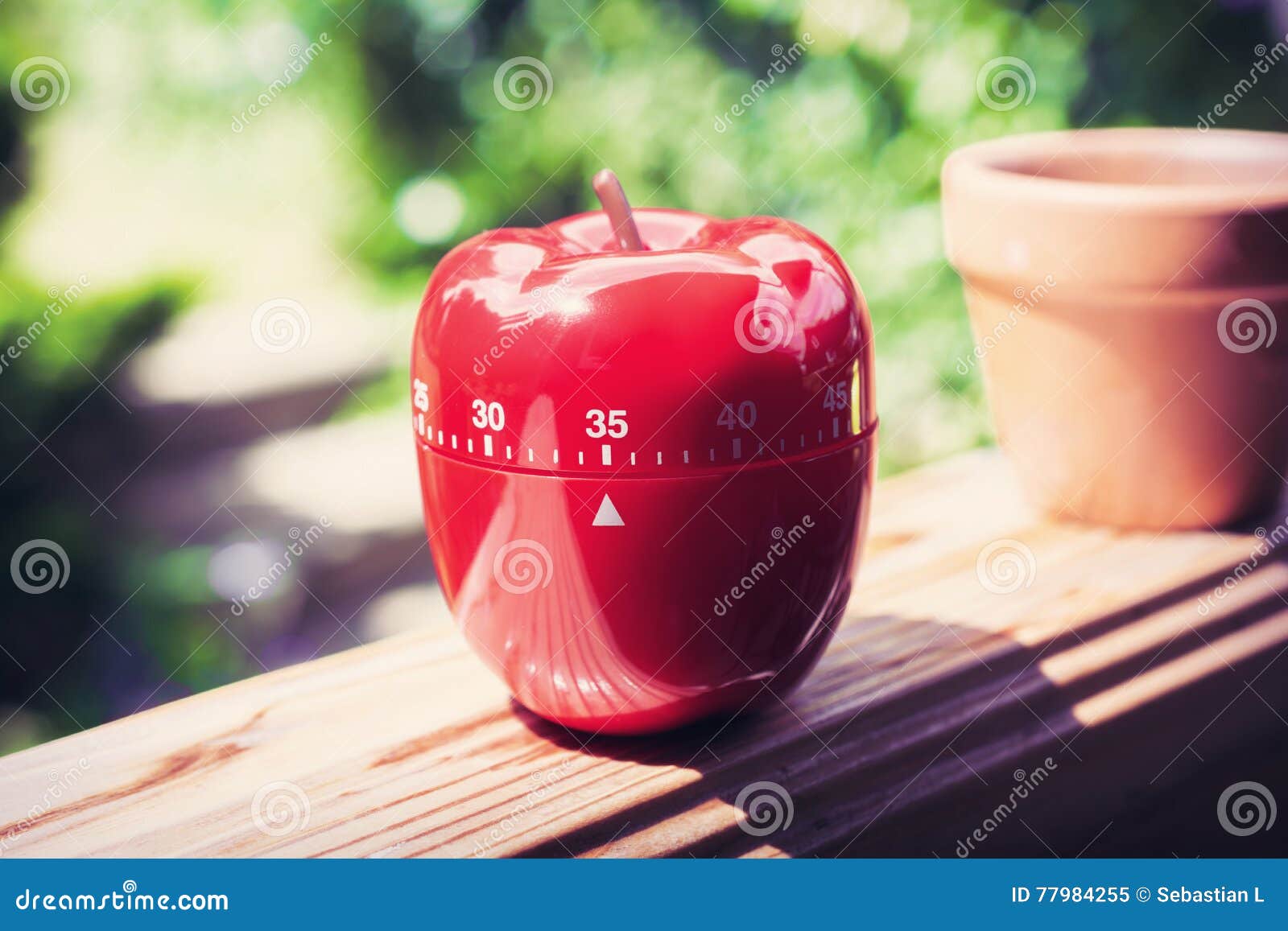 35 Minute Kitchen Egg Timer in Apple Shape Standing on a Handrail Stock ...