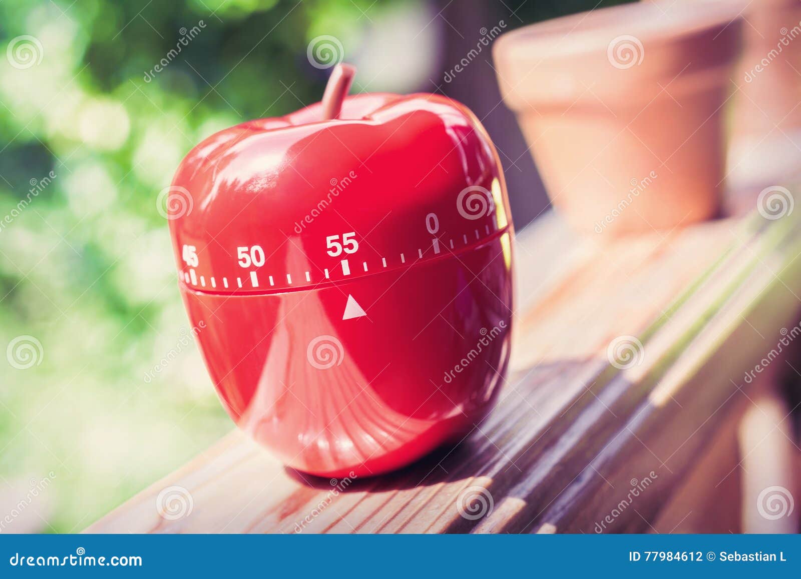 55 Minute Kitchen Egg Timer in Apple Shape Standing on a Handrail Stock ...