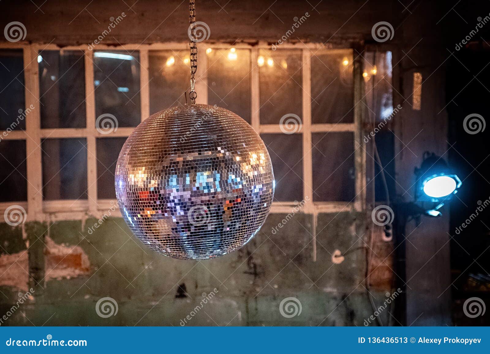 Mirror Ball Under the Ceiling on the Background of Old Walls and ...