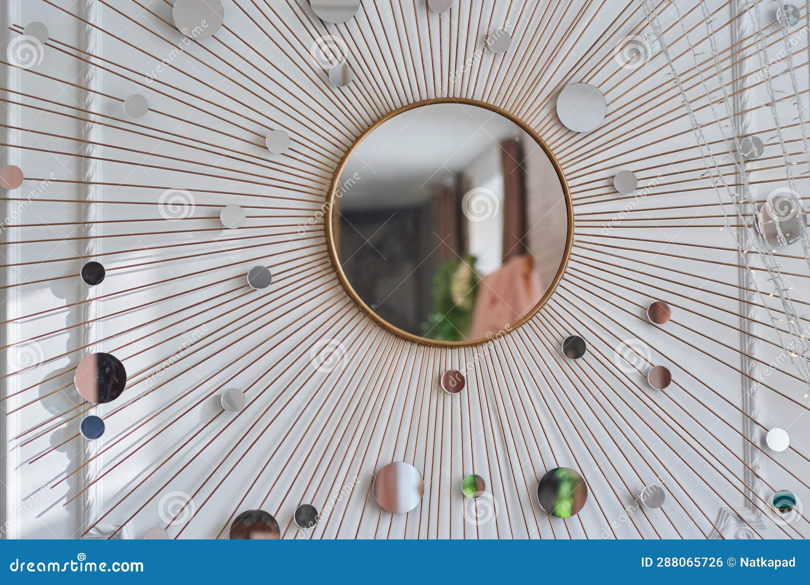 A Mirror in the Form of the Sun with Rays on the Wall in the Room ...