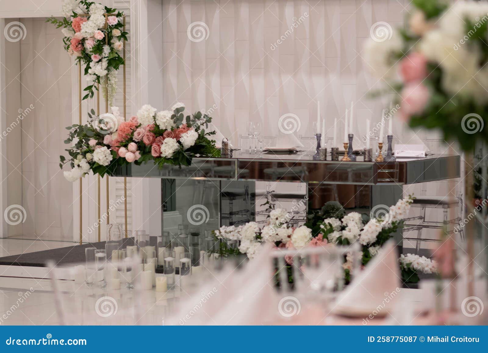 Mirror Main Table at a Wedding Reception with Beautiful Fresh Flowers ...