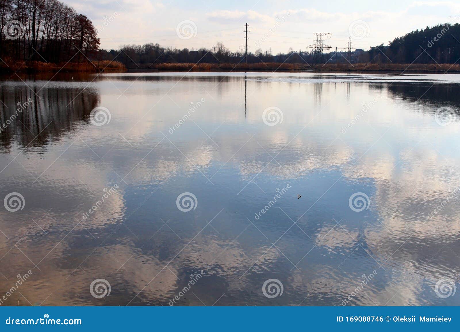 The Mirror Surface of the Lake Reflects the Sky with Clouds Stock Photo ...
