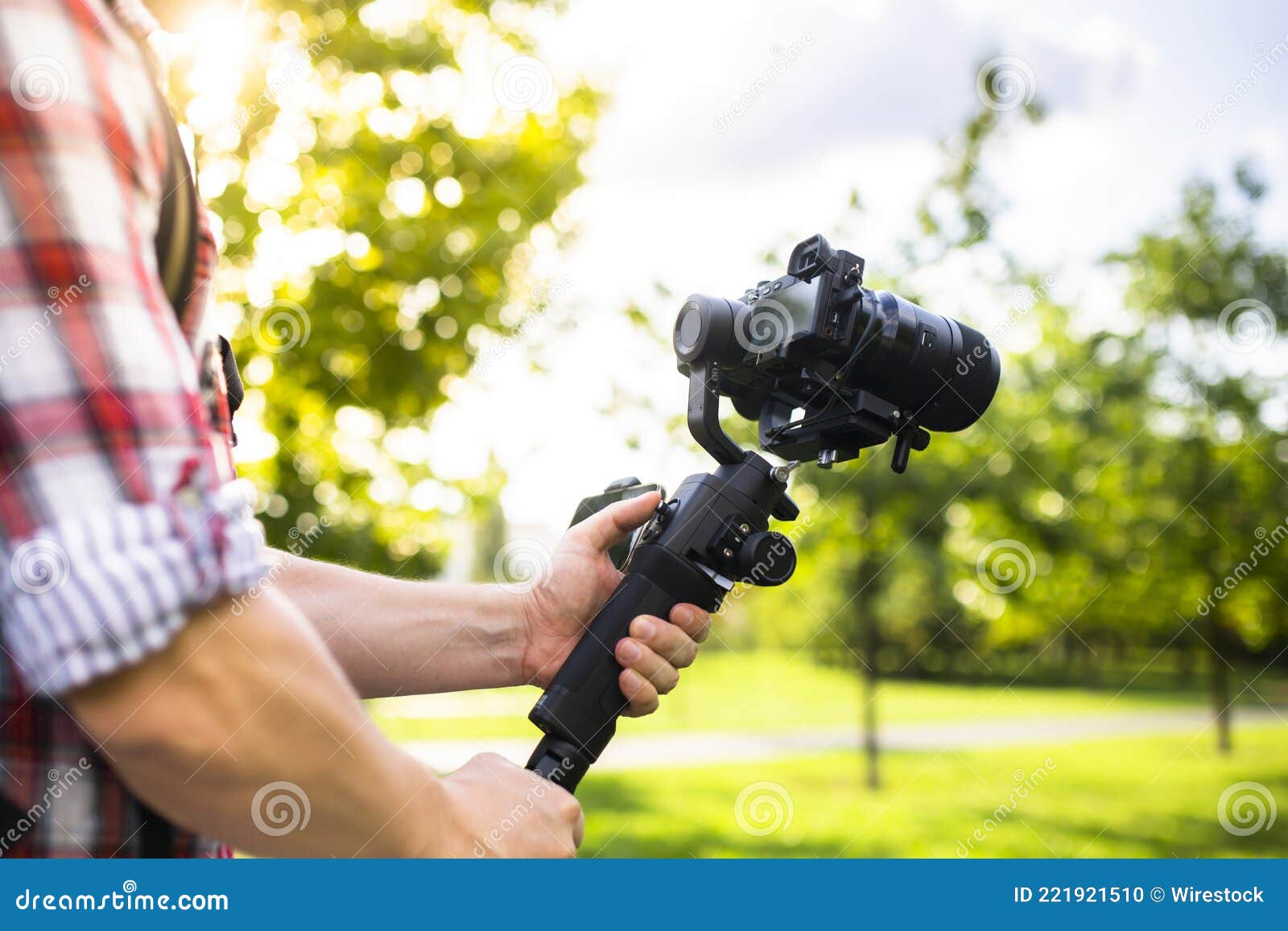 A Man Operating Camera Mounted on a Gimbal, Focus on the Gimbal and ...