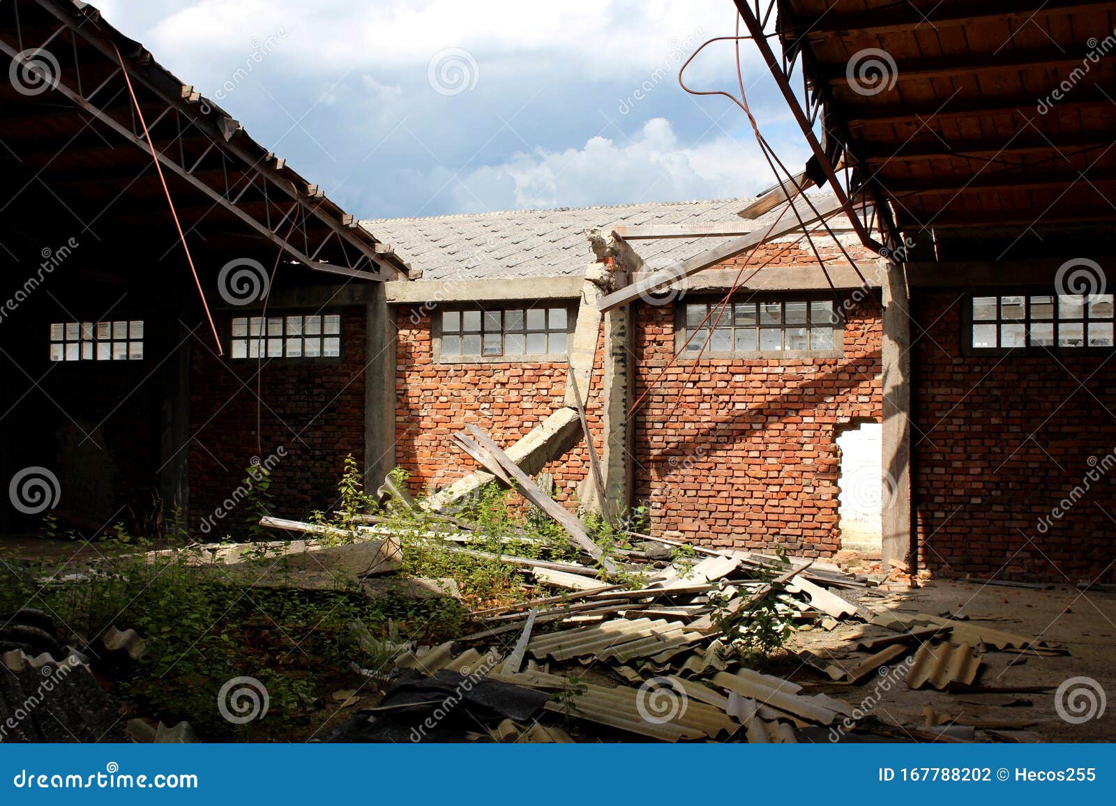 Missing Part of Destroyed Roof of Large Storage Hangar with Piles of ...