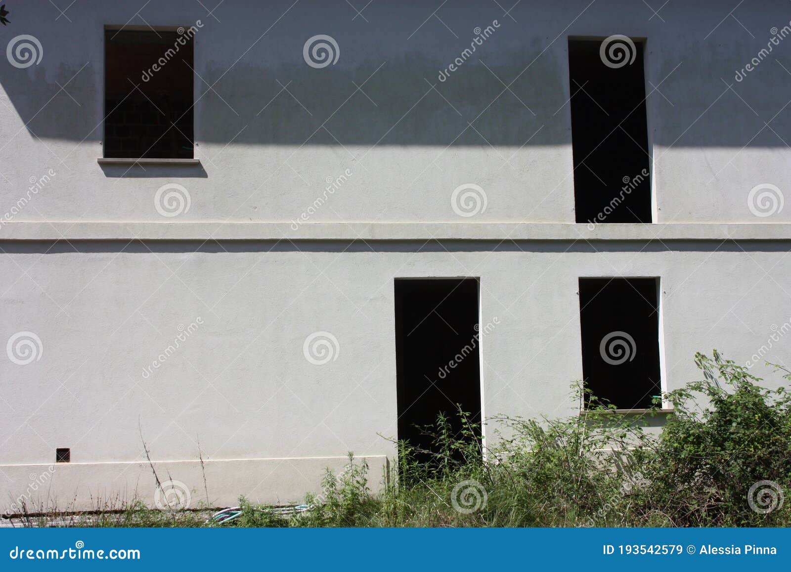 Missing Windows and Door To a Facade of an All White House in Need of ...