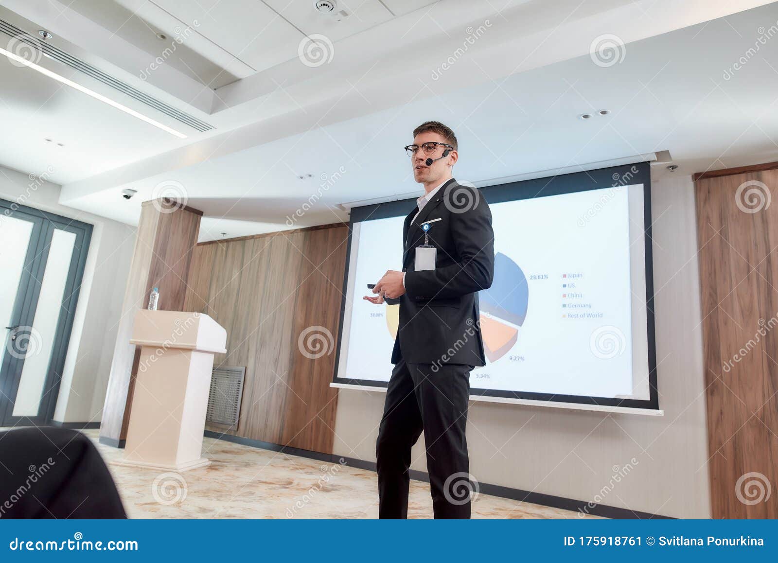 Mission Possible. Young Male Speaker with Headset and Laser Pointer in ...