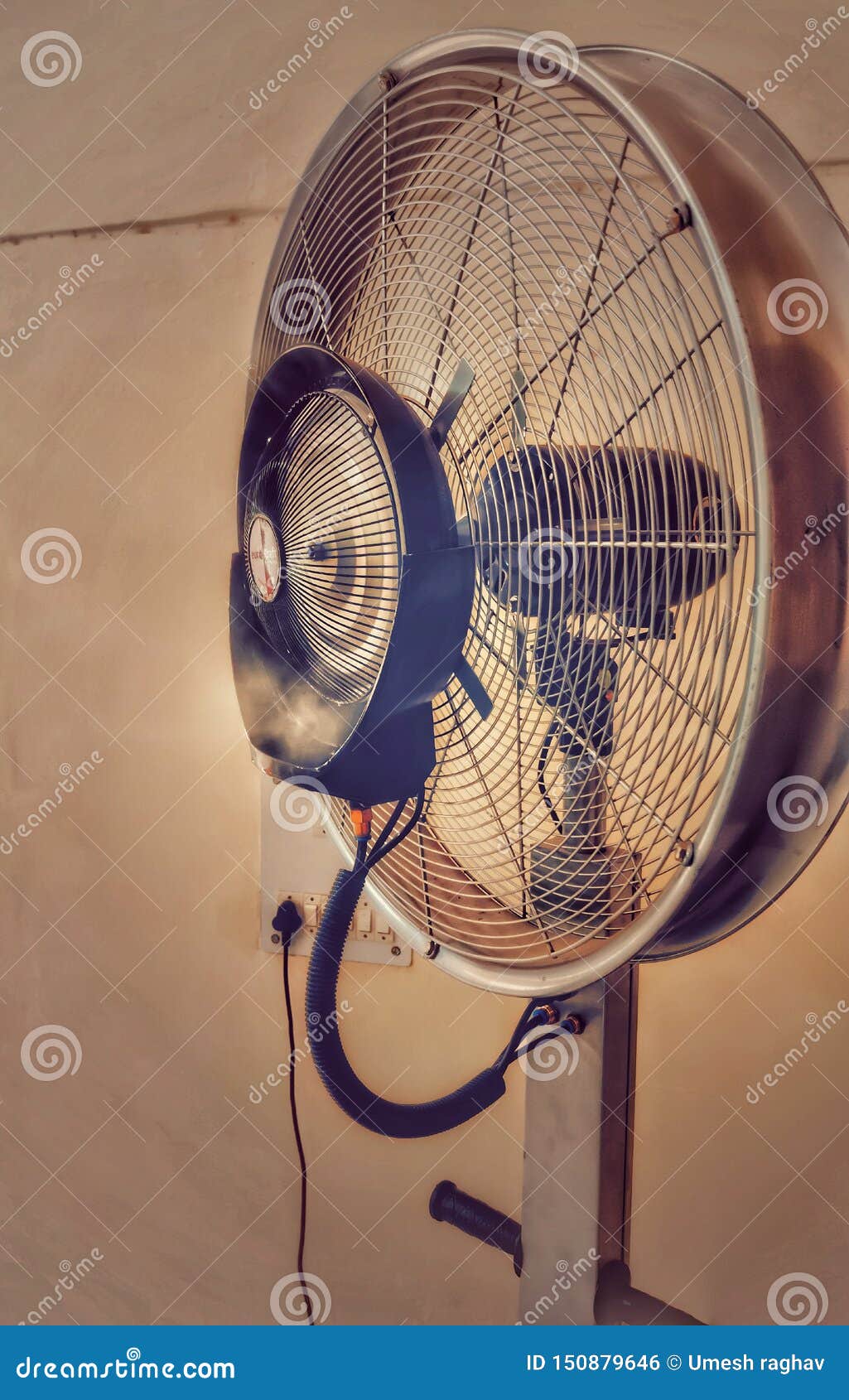 A Mist Fan Running and Throwing Water Stock Photo - Image of water ...