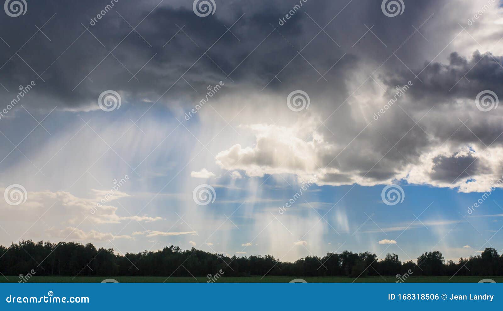 Misty Rain and Dark Clouds in Blue Sky Over Field and Trees Stock Photo ...