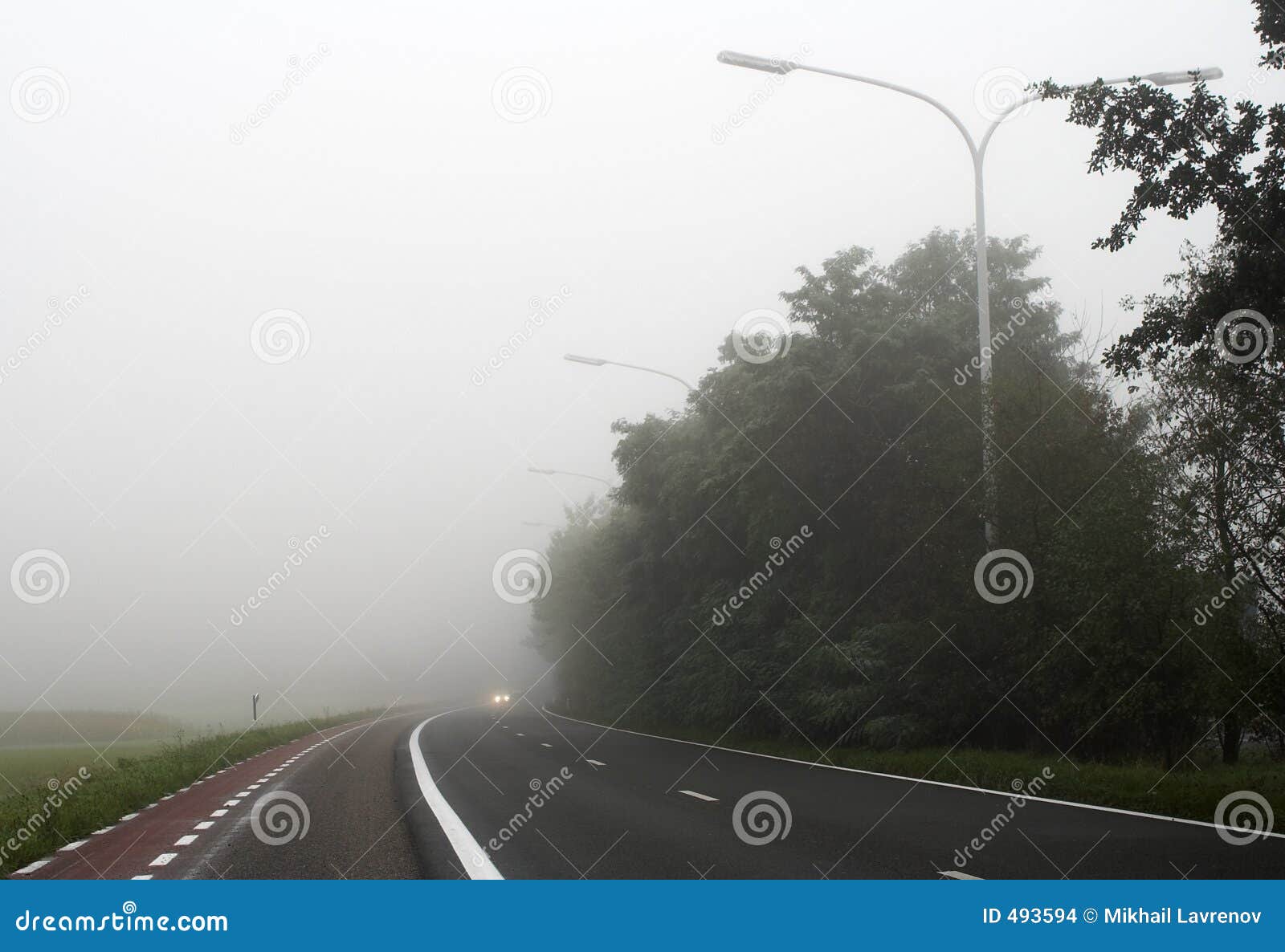 Misty Road with Car Headlights Far Away Stock Photo - Image of light ...