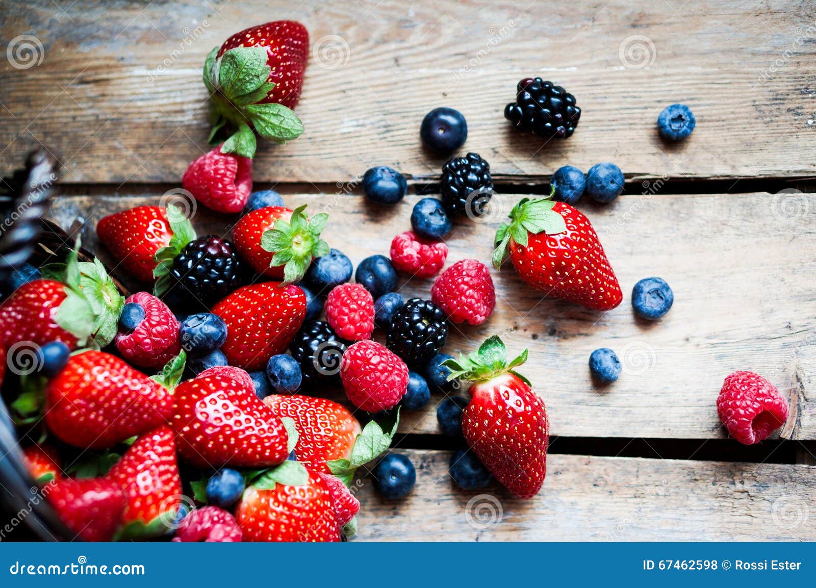 Mix of Fresh Berries in a Basket on Rustic Wooden Background Stock ...