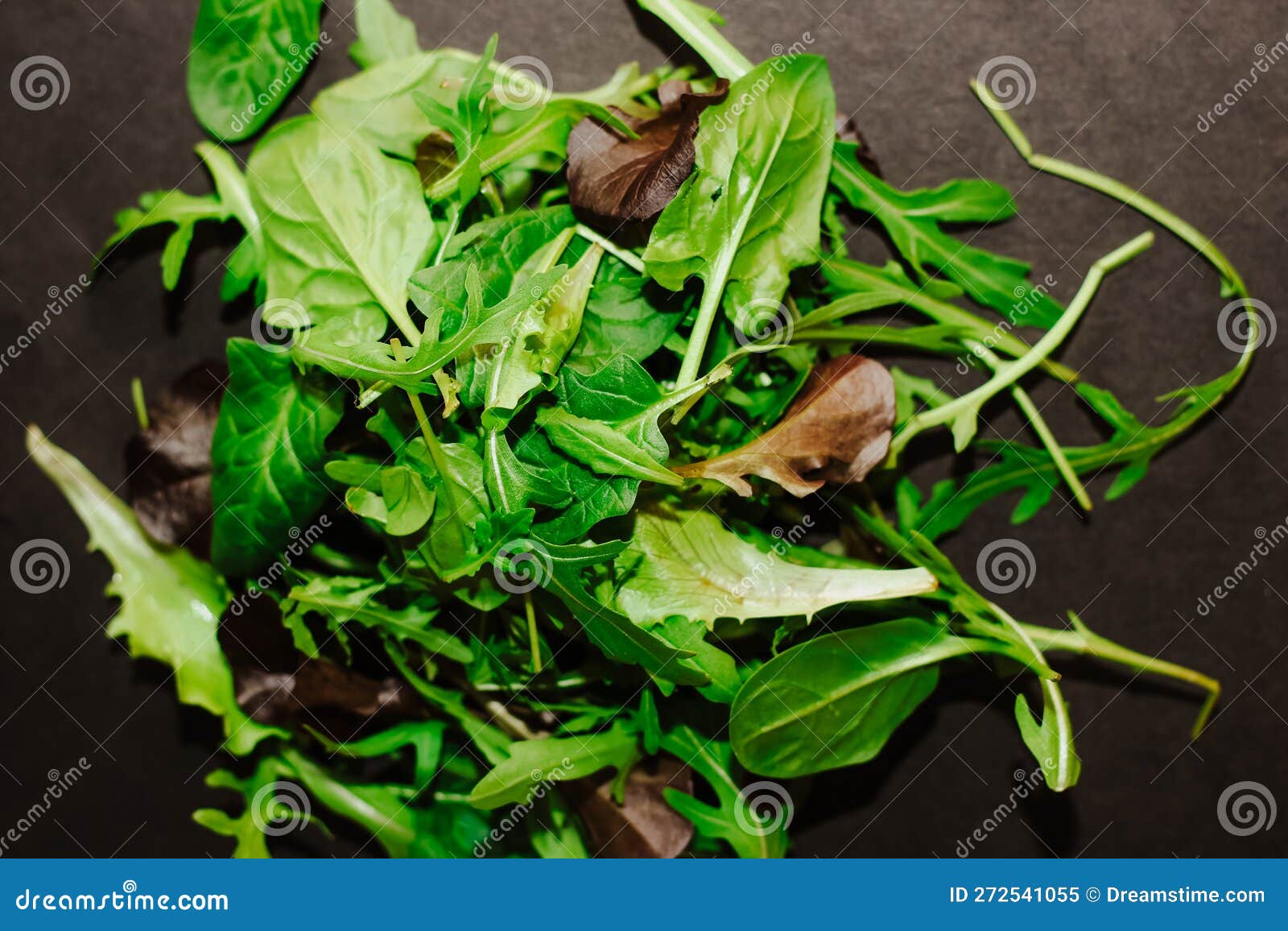 Mix of Lettuce Leaves Different Types on Black Table. Stock Image ...
