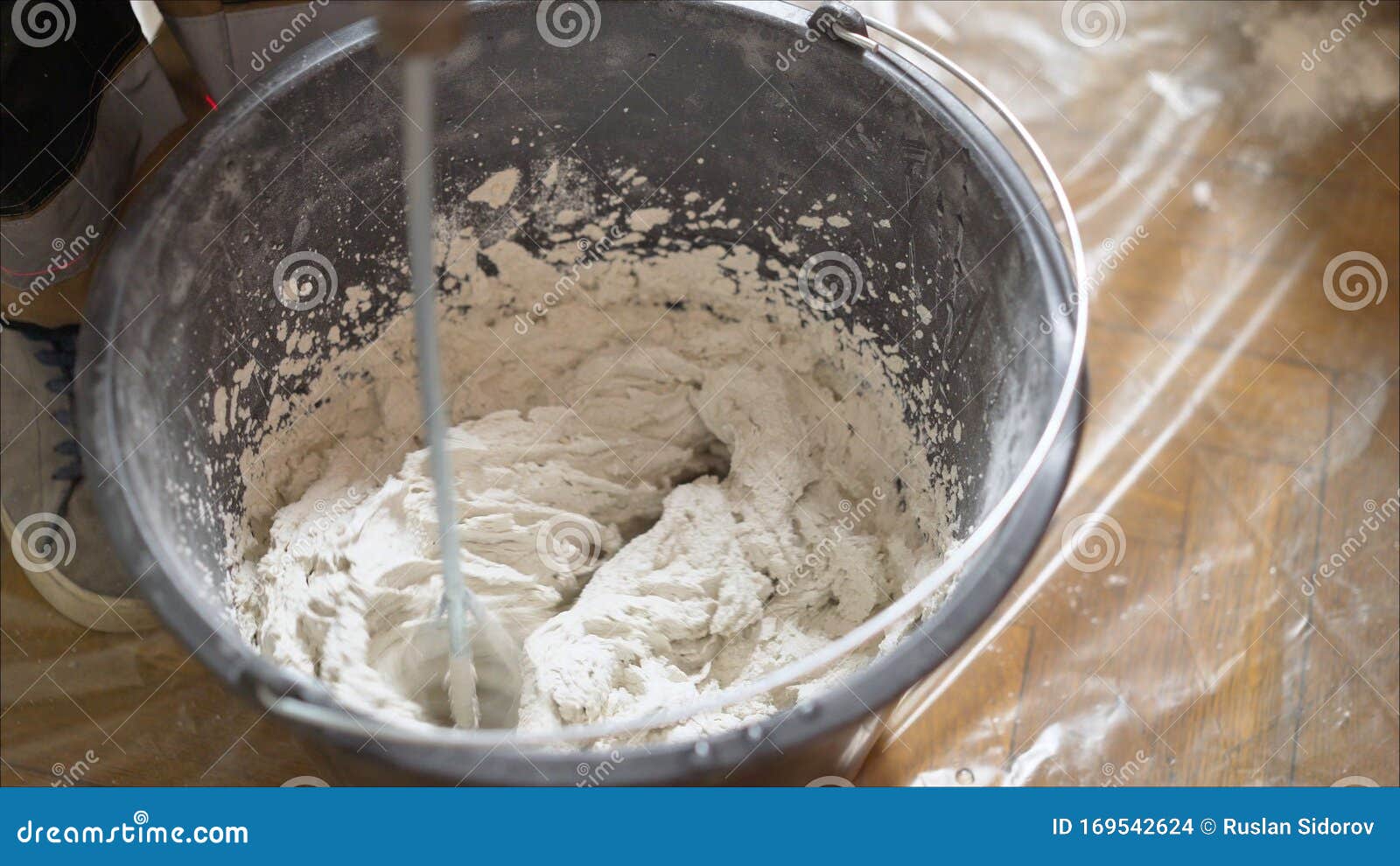 Mix the Solution in a Bucket Using a Construction Mixer. Worker Mixing ...