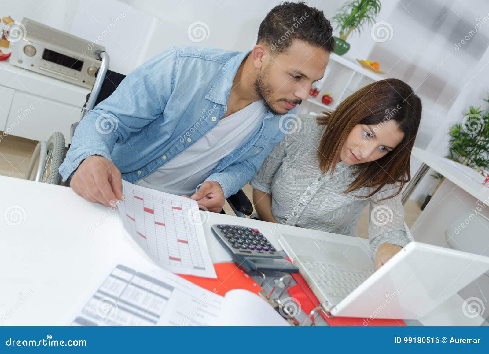 Mixed Couple Doing Paperwork at Table Stock Photo - Image of casual ...