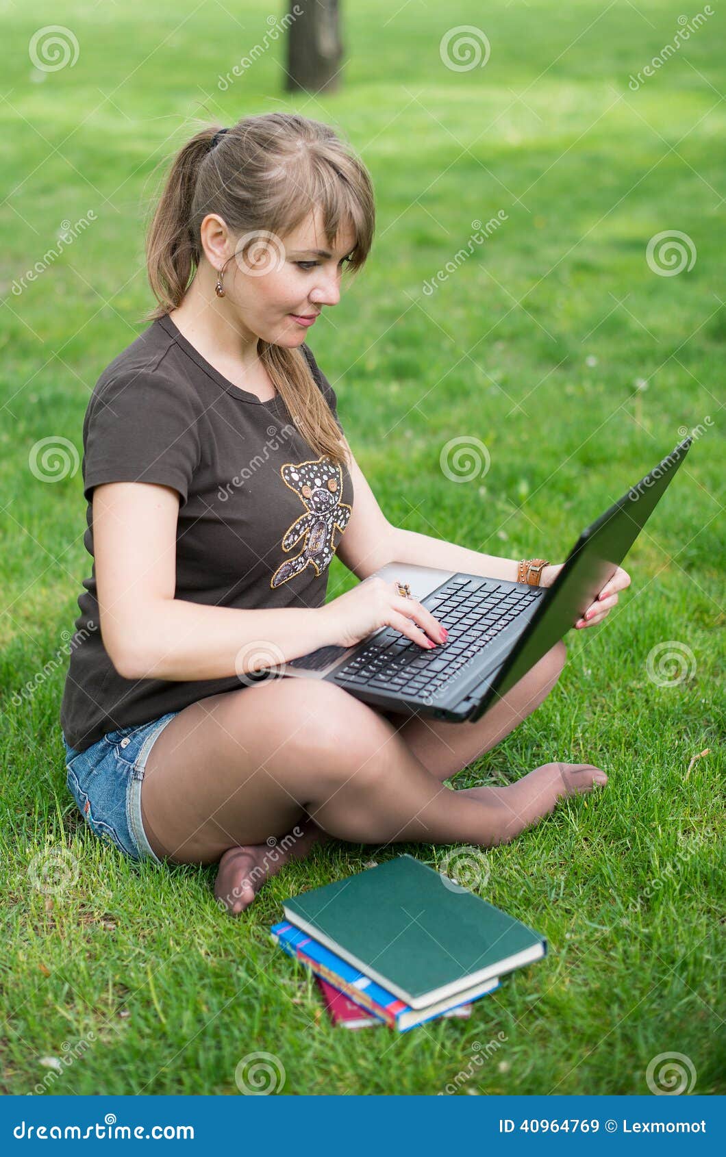 Mixed Race College Student Sitting on the Grass Working Stock Image ...